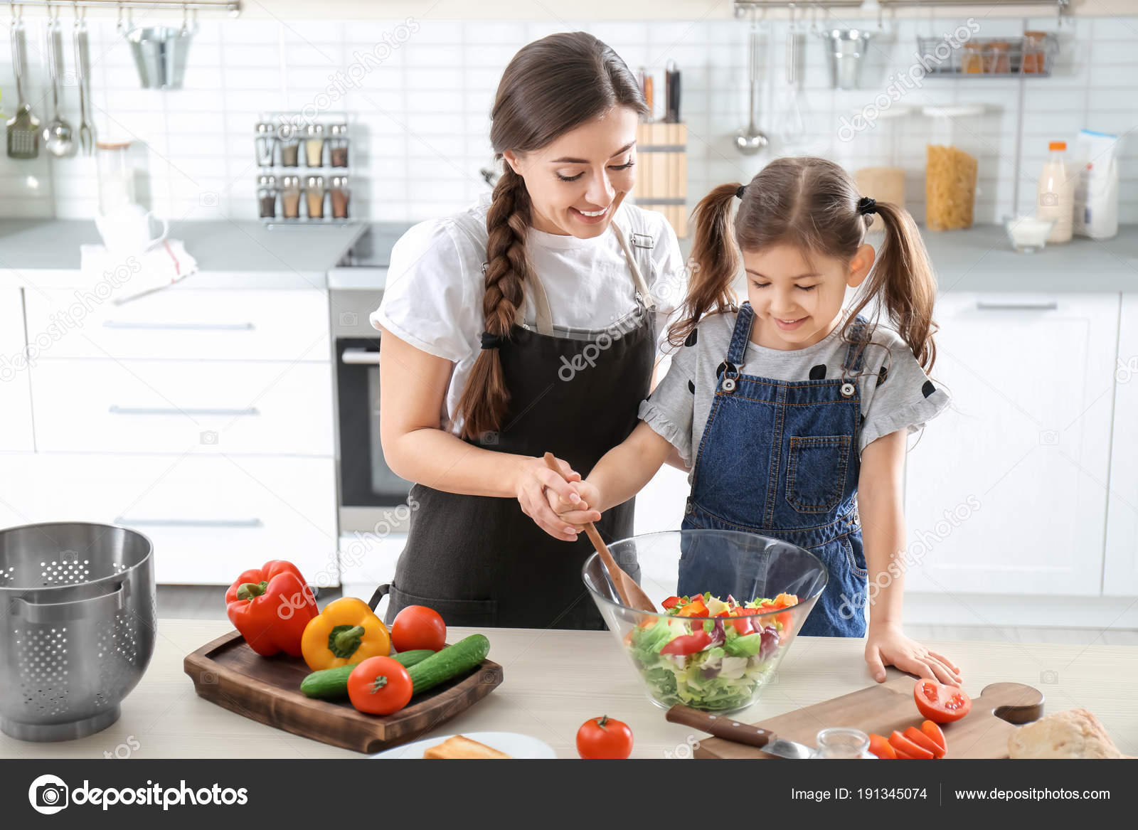 Young nanny with cute little girl cooking together in kitchen — Stock ...