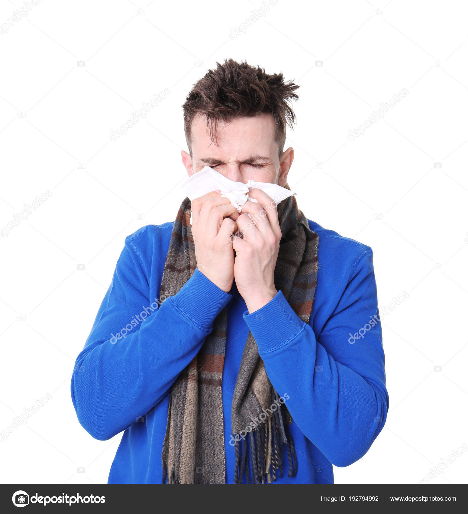 Young man with cold sneezing on white background Stock Photo by ...