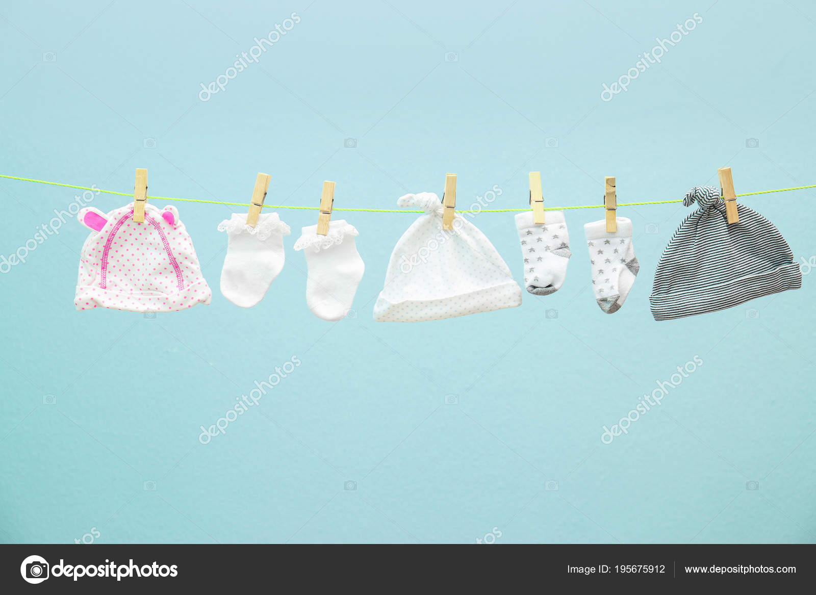 Children's clothes on laundry line against color background Stock Photo ...
