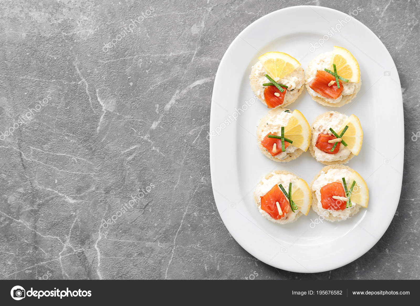 Canapes with fresh sliced salmon fillet on table, top view Stock Photo ...