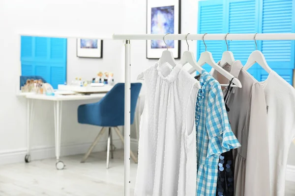 Wardrobe rack with stylish clothes indoors, closeup Stock Photo by ...