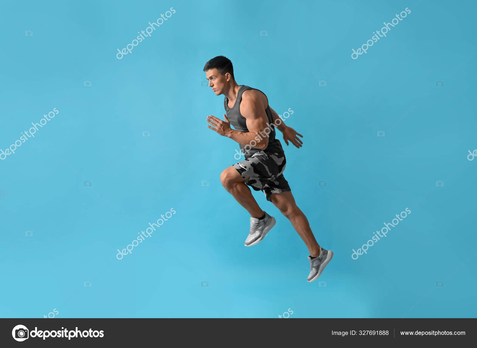 Athletic young man running on light blue background, side view — Stock ...