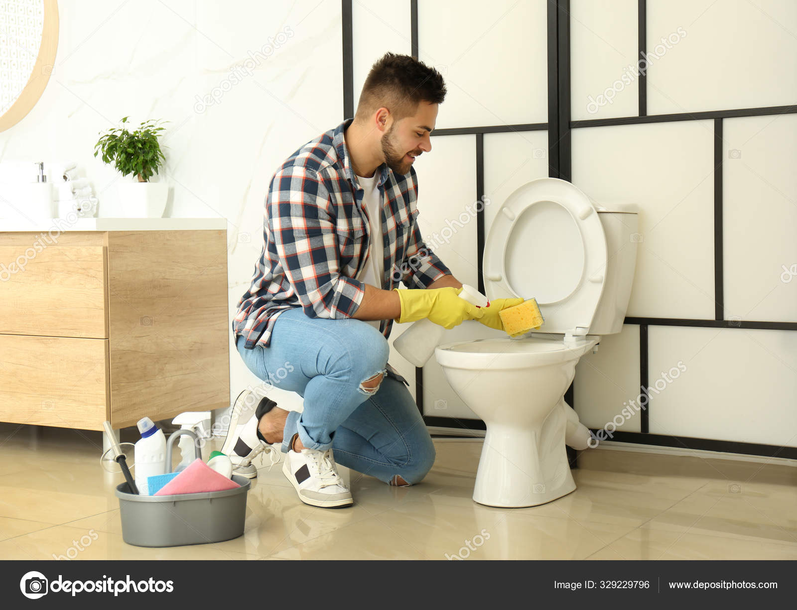 Man Cleaning The Bathroom