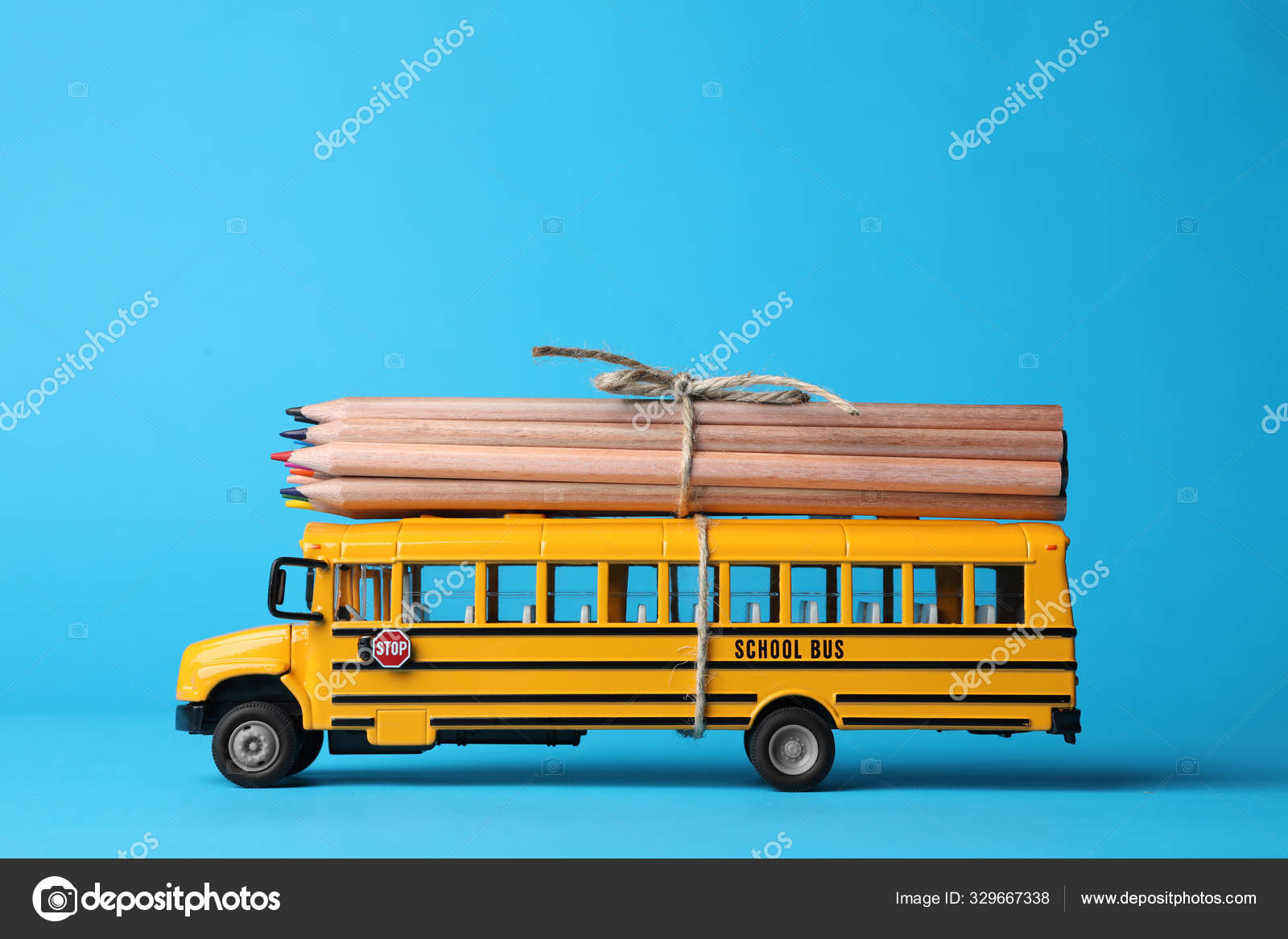 School bus model with color pencils on light blue background. Tr Stock ...