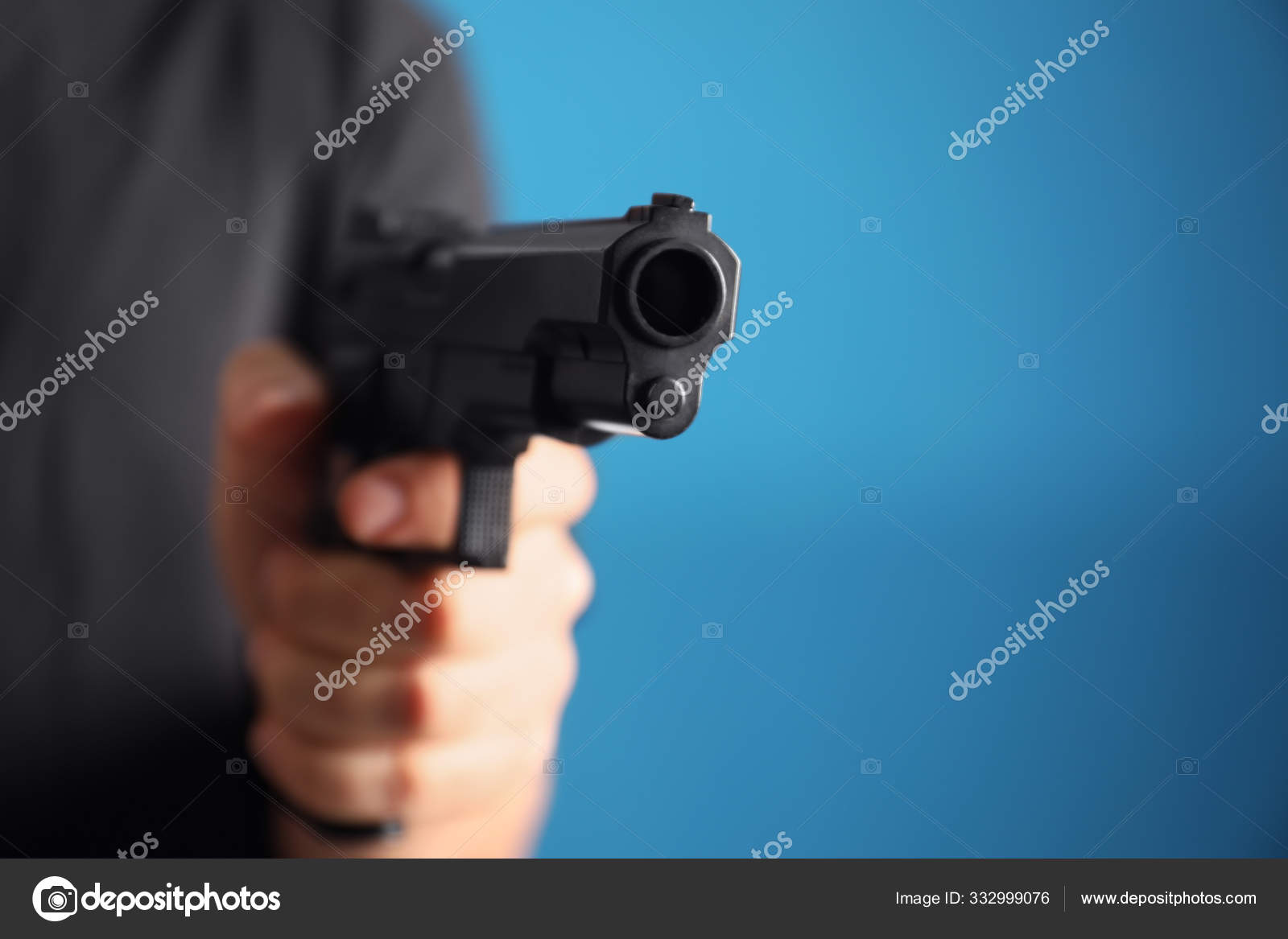 Man Holding Gun Blue Background Closeup Stock Photo by ©NewAfrica 332999076