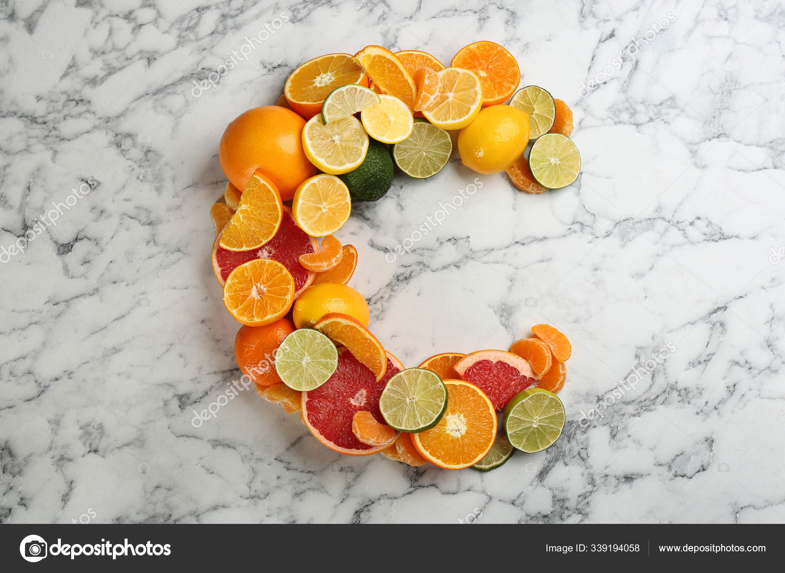 Letter C made with citrus fruits on marble table as vitamin repr ...