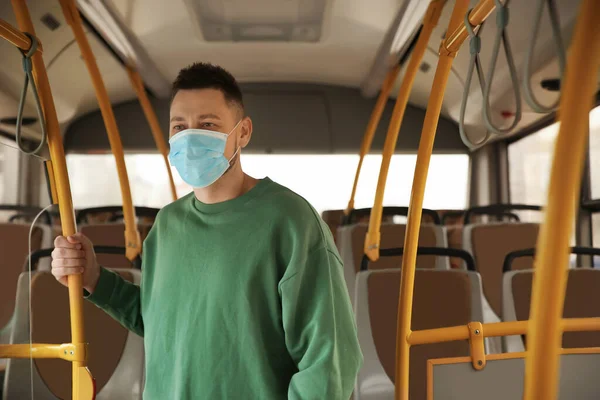 Man with disposable mask on bus. Virus protection - Stock Image ...