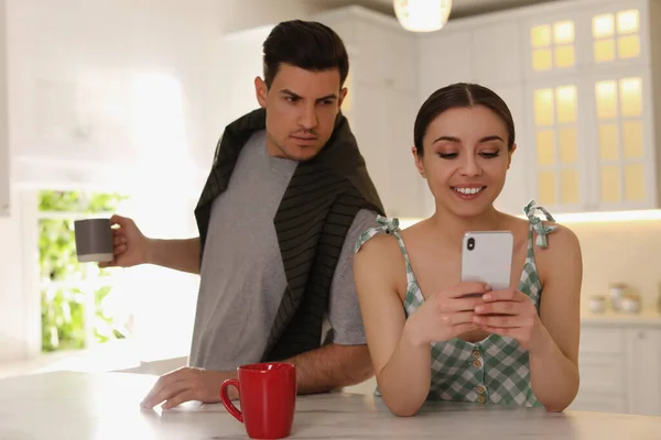 Young man preferring smartphone over his girlfriend at home Stock Photo ...