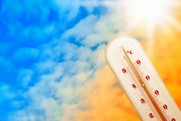 Weather thermometer with high temperature and color sky on background ...