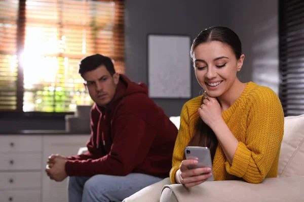 Young man preferring smartphone over his girlfriend at home Stock Photo ...