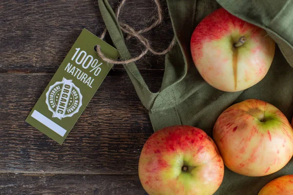 Apples and cotton bag with a label 100 natural product. Organic stuff ...