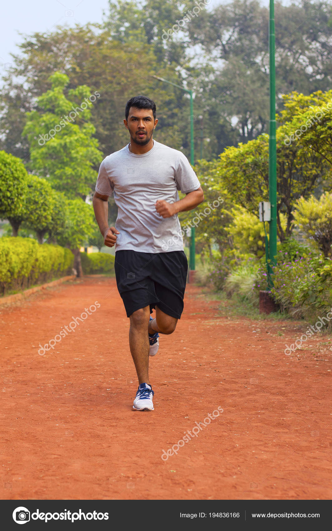 Young guy running on a jogging track — Stock Photo © RealityImages ...