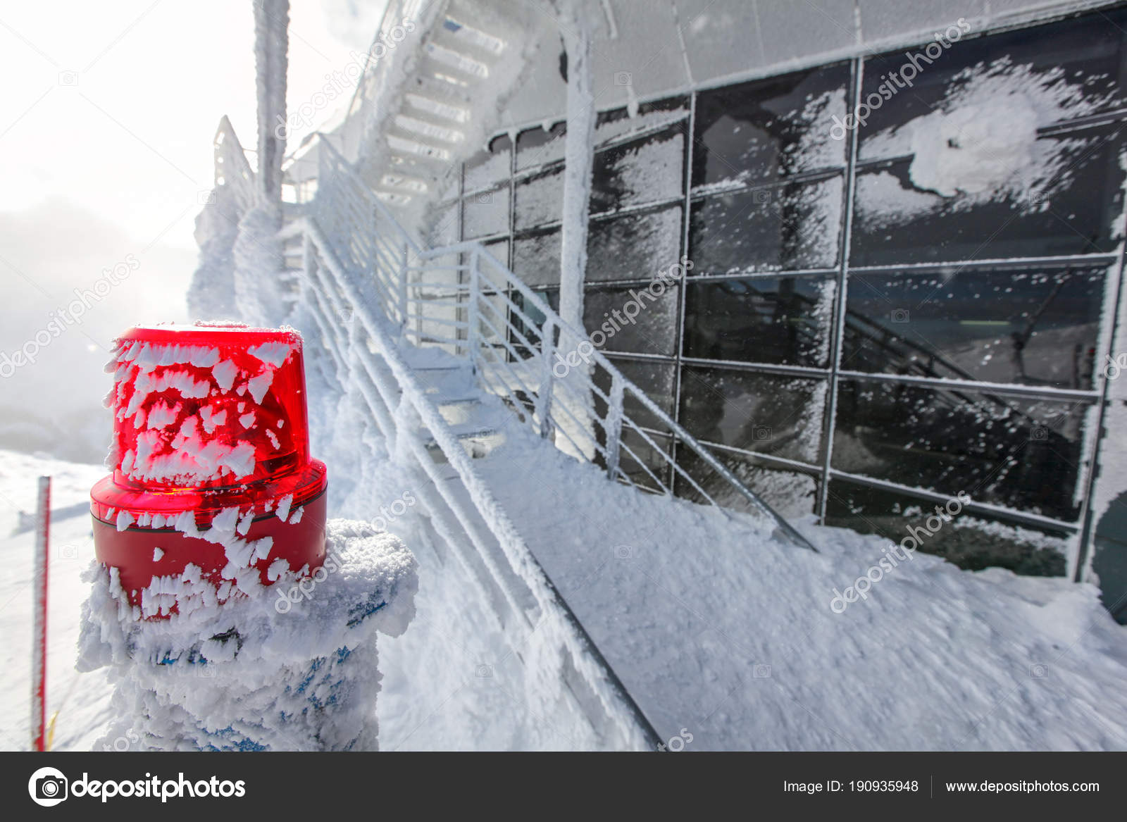 Red emergency lighting with snow and ice covered stairs Stock Photo by ...