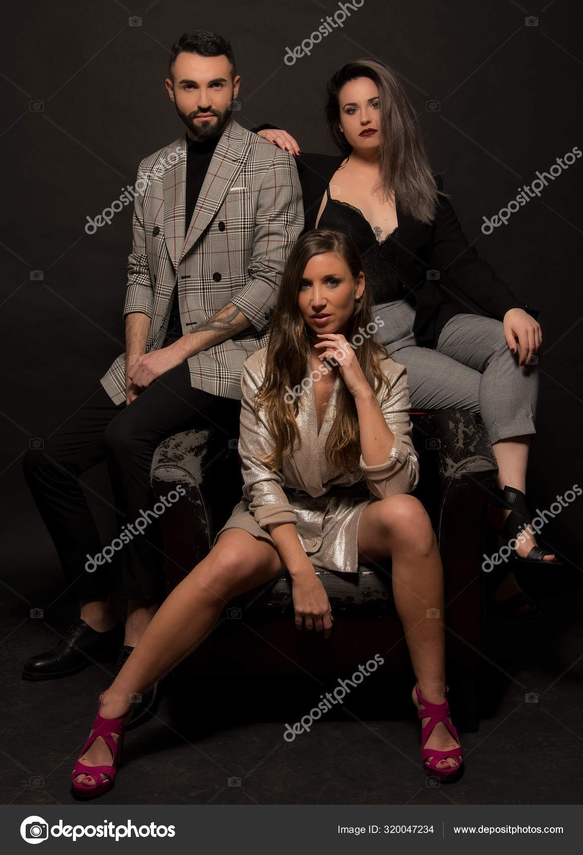 Trio of models with gray and black clothes in the studio — Stock Photo ...