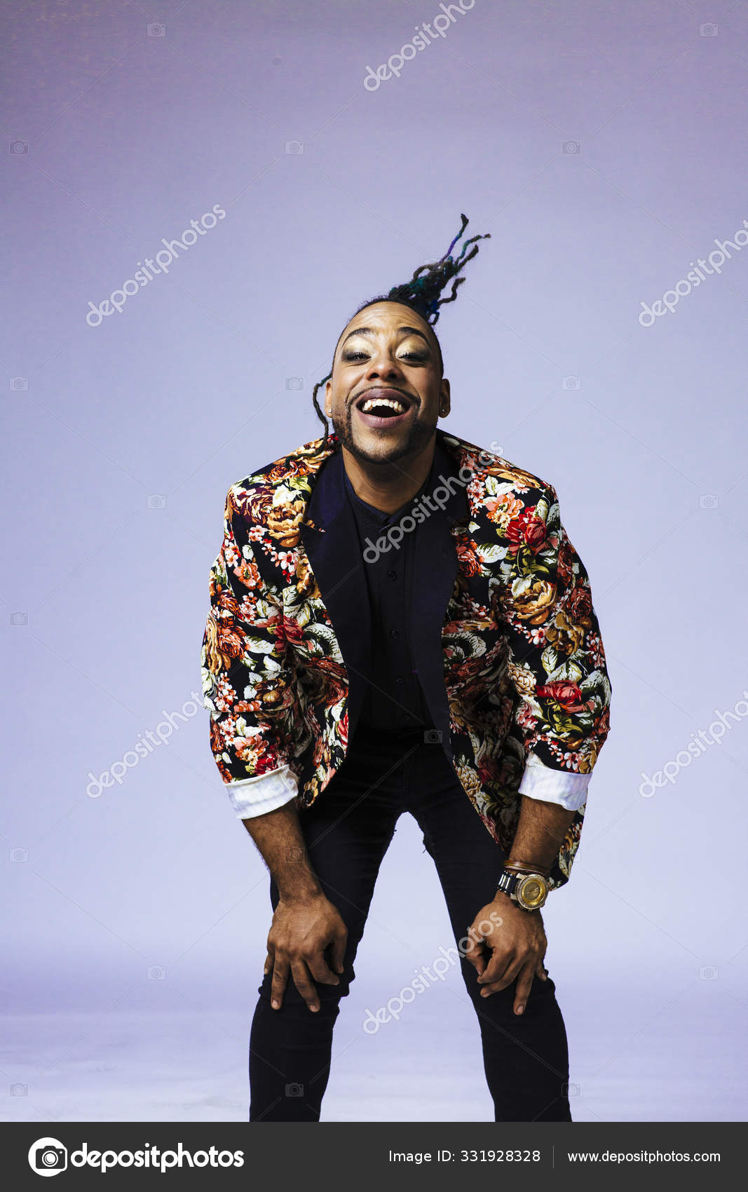 Studio portrait of a man wearing a flower patterned suit and dreadlocks ...