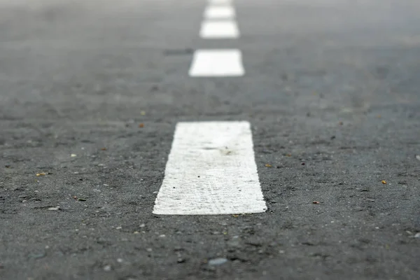 Road Marks. white stripes on the road stretching into the distance ...
