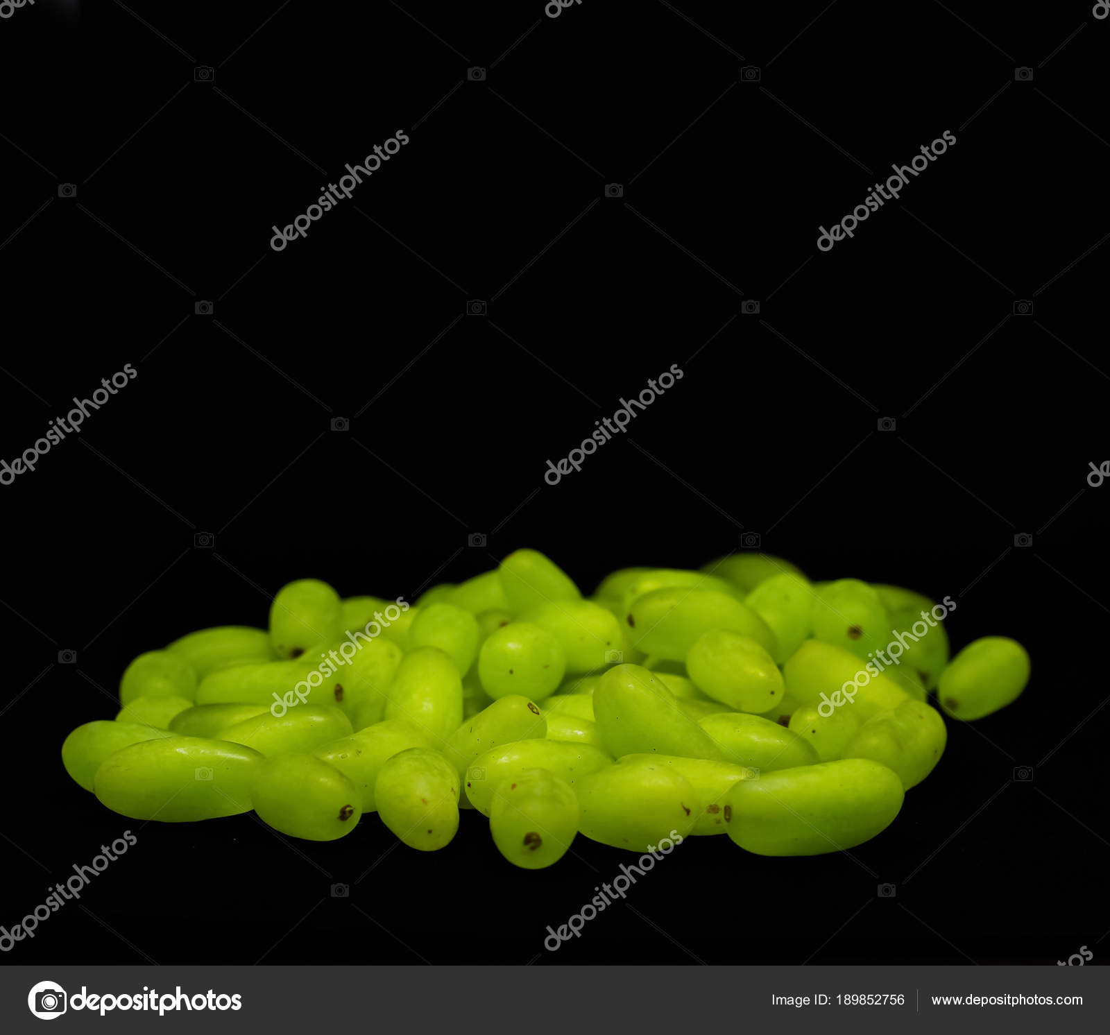 Green grape without branches and leaves isolated on black. With ...