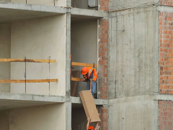 Construction worker balancing between scaffold and formwork fram ...