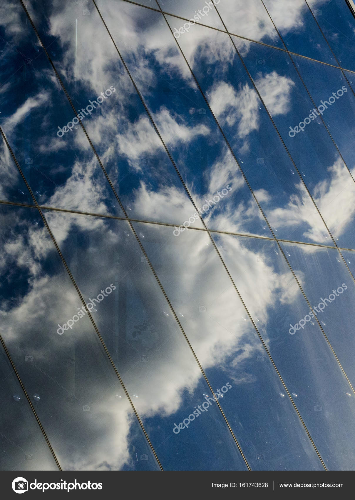 Reflection of clouds and blue sky in the glass wall of a modern — Stock ...