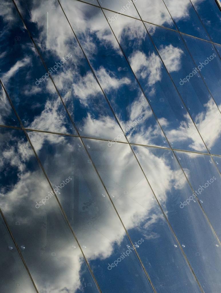 Reflection of clouds and blue sky in the glass wall of a modern — Stock ...