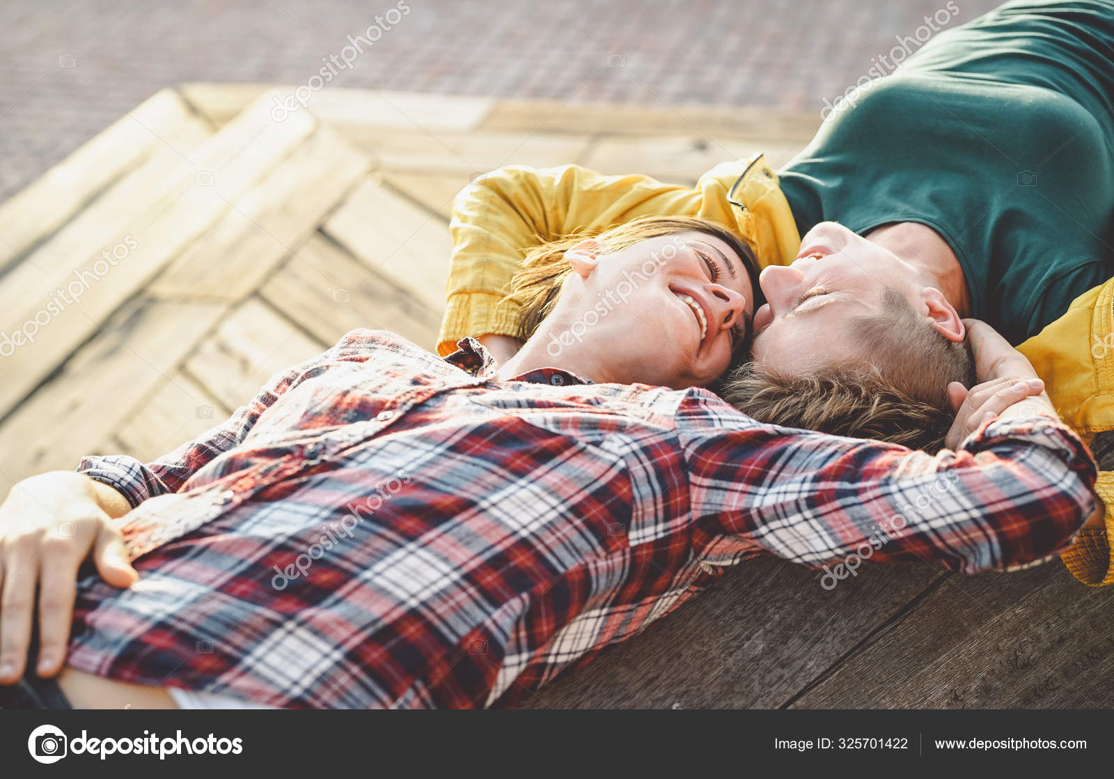 Happy Gay Couple Lying On A Bench Looking Each Other Young Lesbian