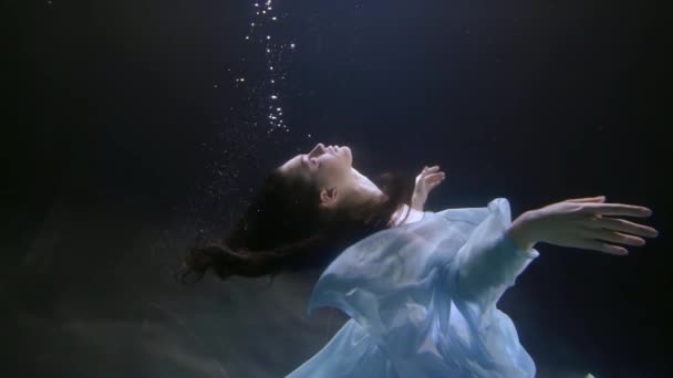 Magic fairy is floating underwater in depth of swimming pool in ...