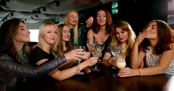 women with drinks celebrate holiday in modern nightclub - Stock Image ...