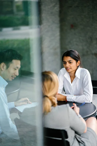 young Indian Asian woman is interviewing for a job and is speaking with ...