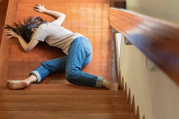 unconscious woman falling down from staircase - Stock Image - Everypixel