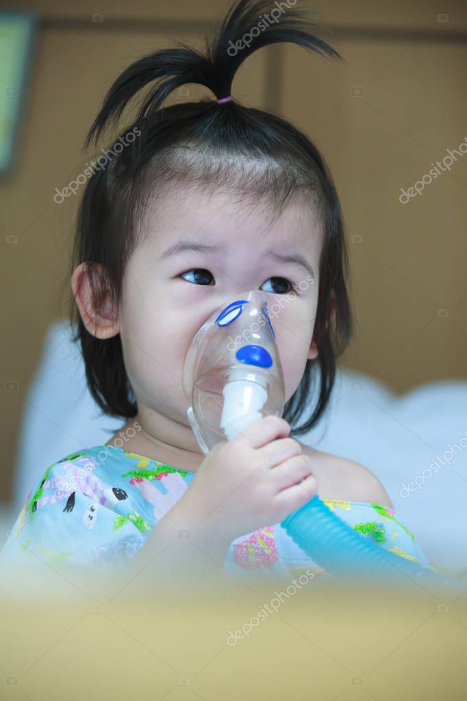 Asian child holds a mask vapor inhaler for treatment of asthma. Stock ...