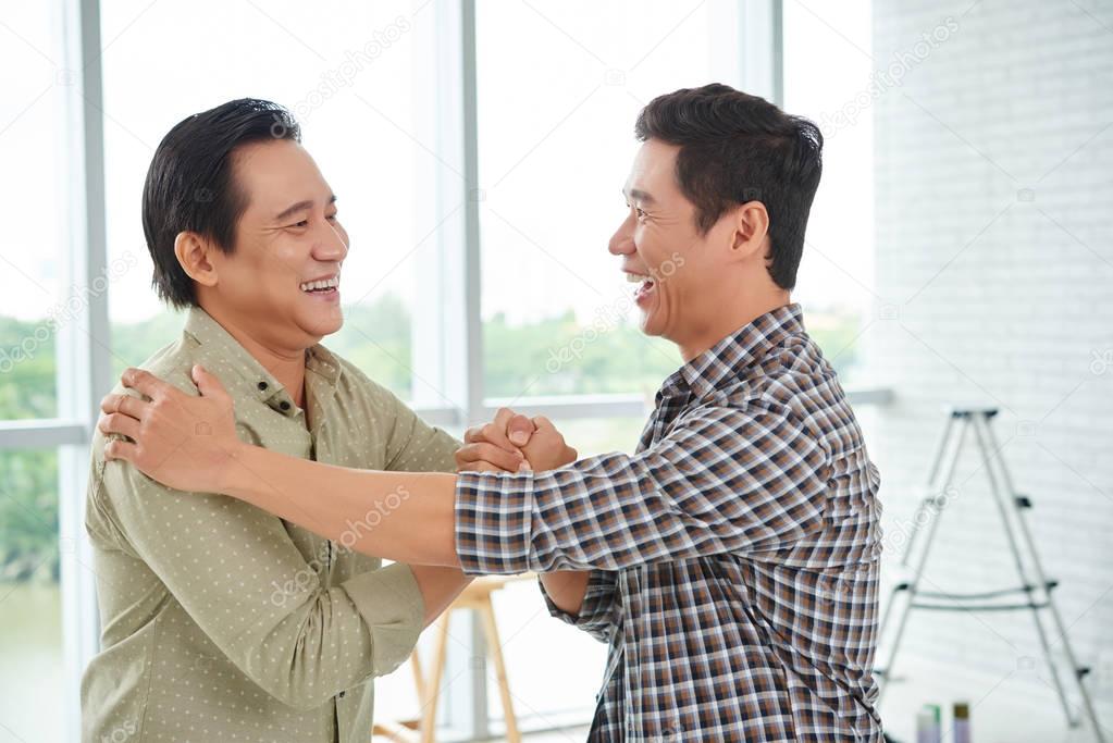 Men greeting each other Stock Photo by ©DragonImages 129090460