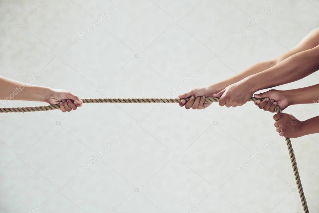 Hands of rivals pulling tug of war Stock Photo by ©DragonImages 129210444