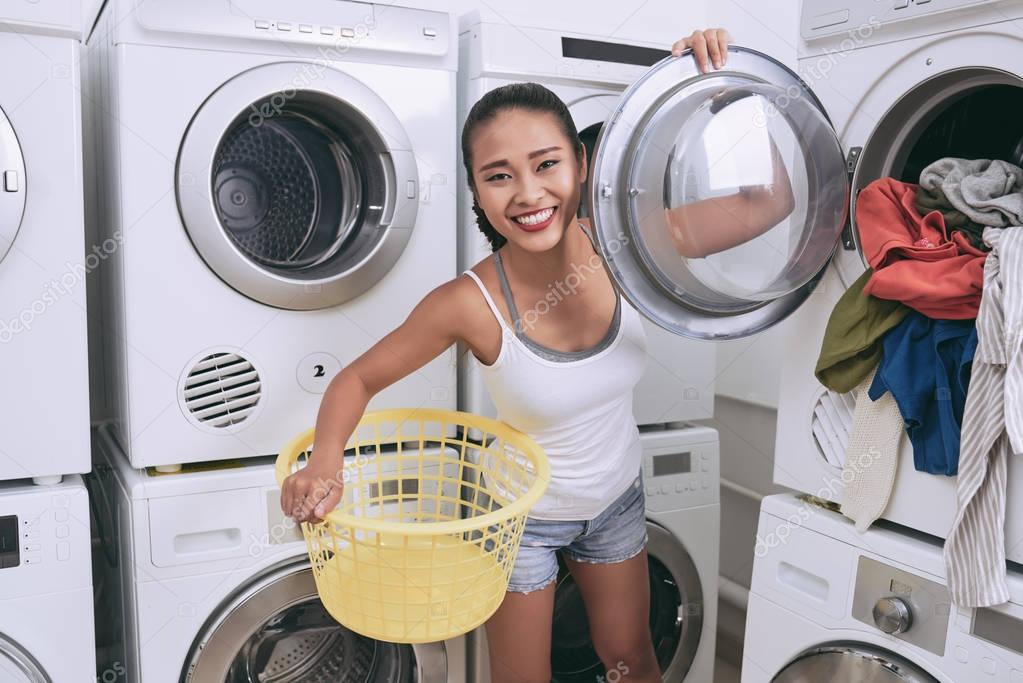 Woman taking fresh clean clothes out Stock Photo by ©DragonImages 129299136