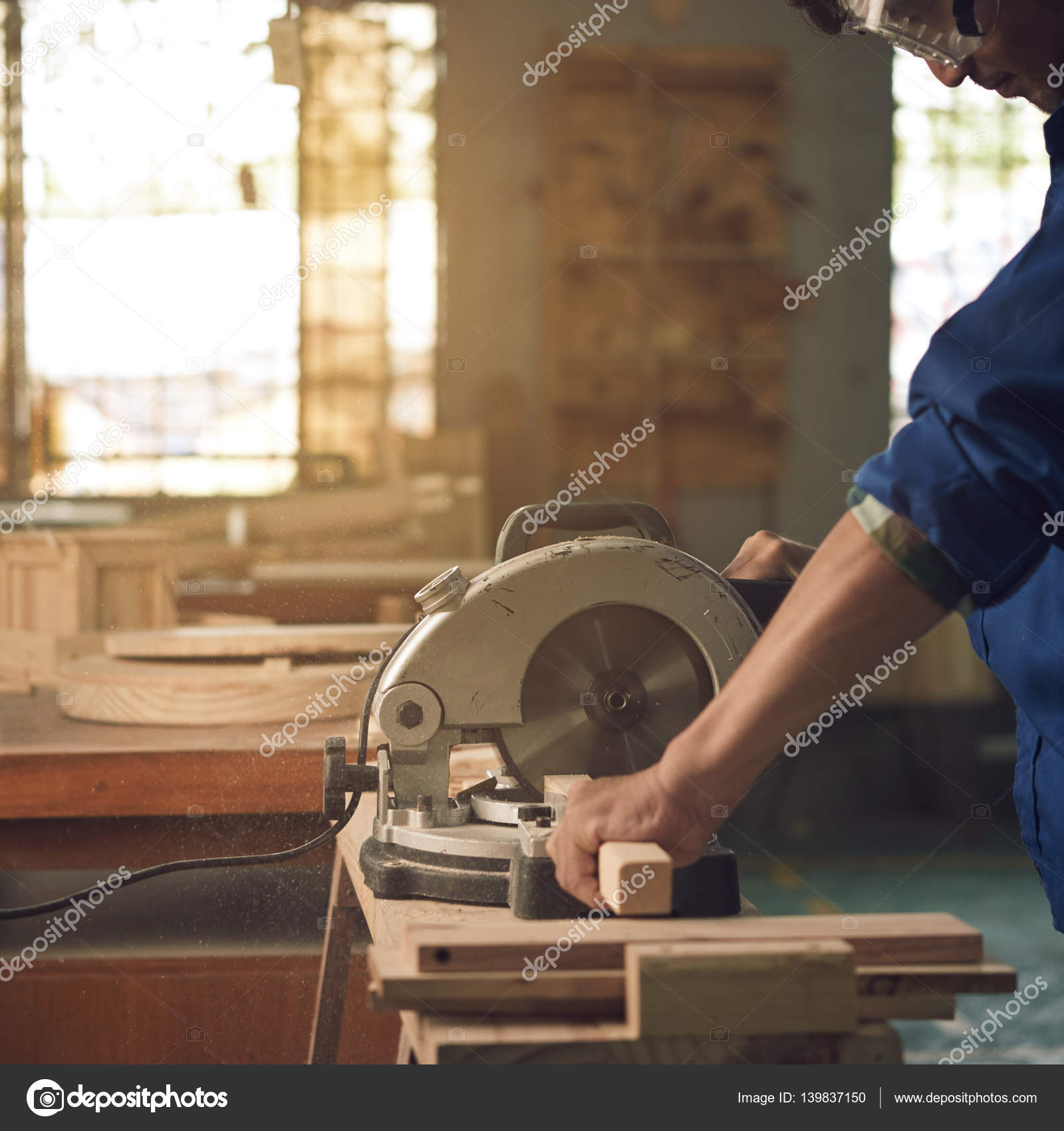 Carpenter using circular saw Stock Photo by ©DragonImages 139837150