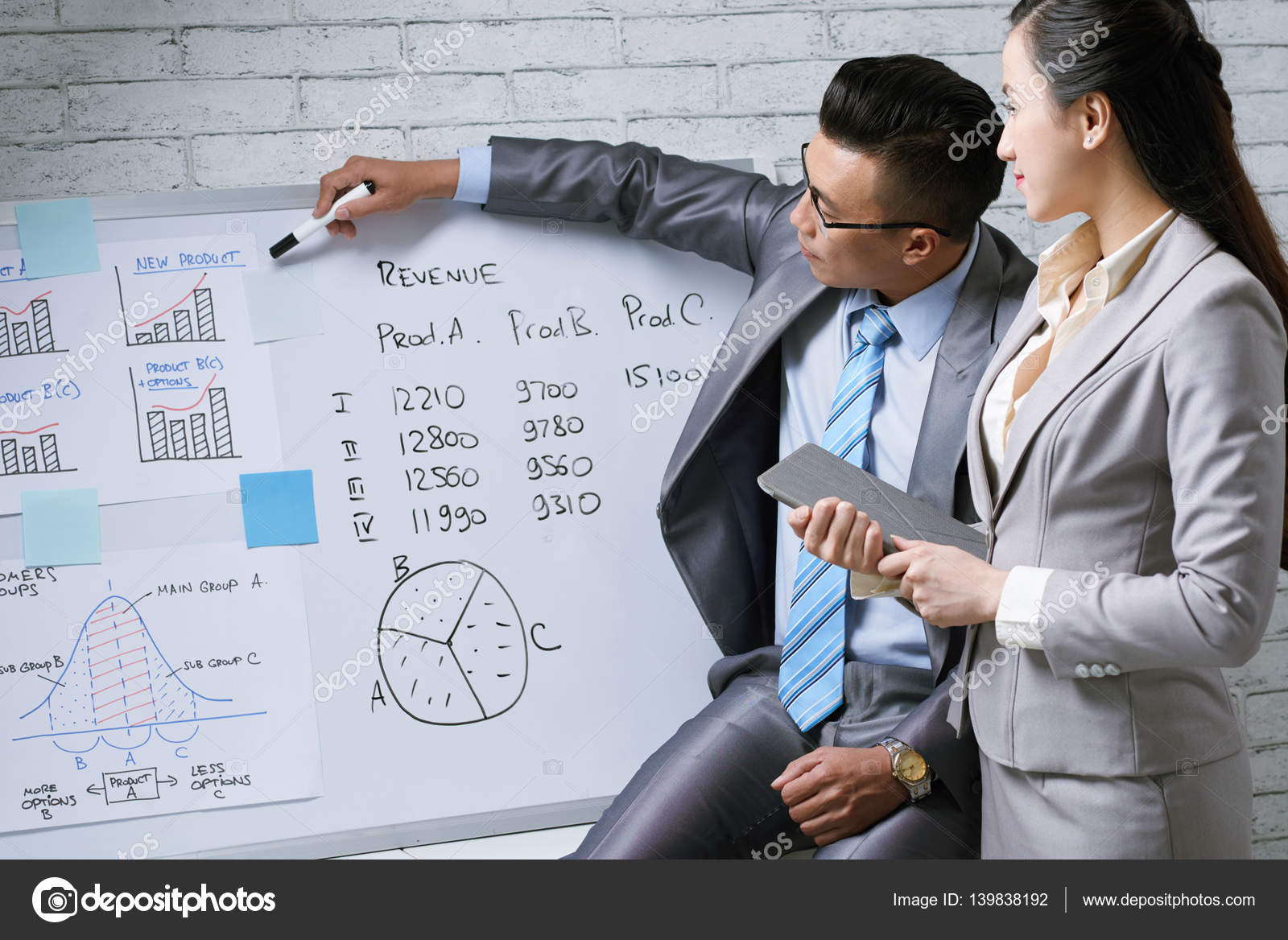 Businessman explaining charts to coworker Stock Photo by ©DragonImages ...