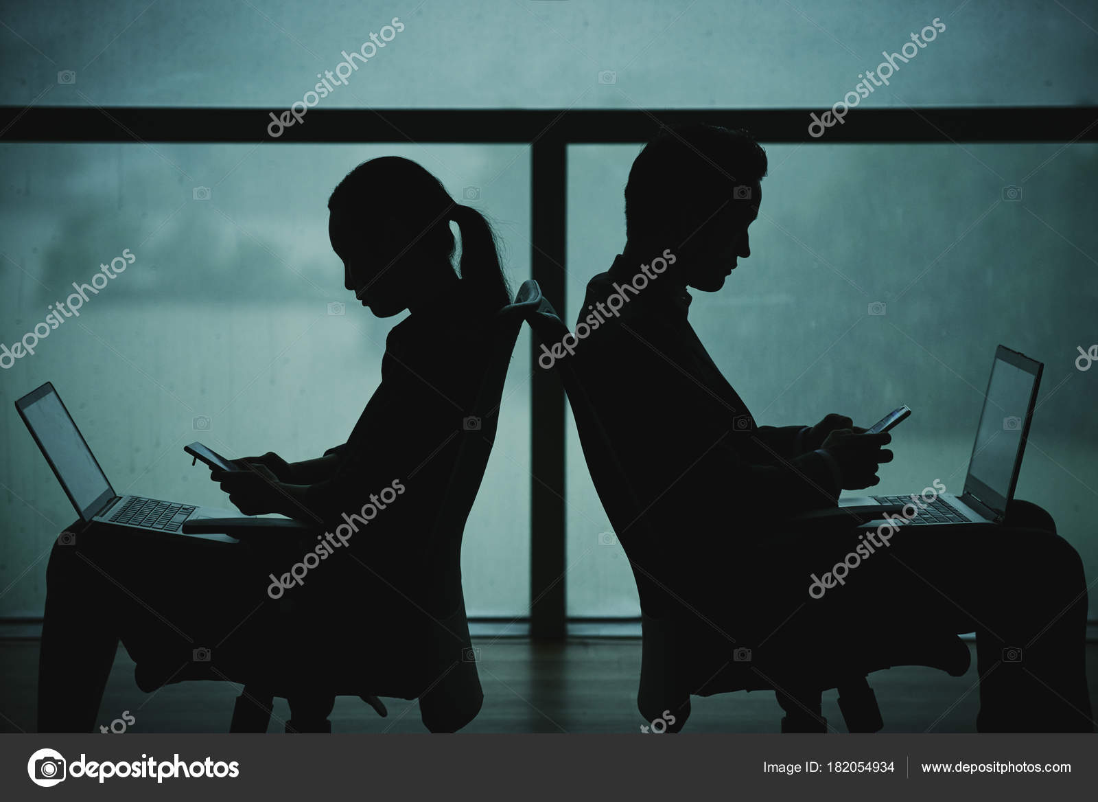 Silhouettes Sitting At Computer