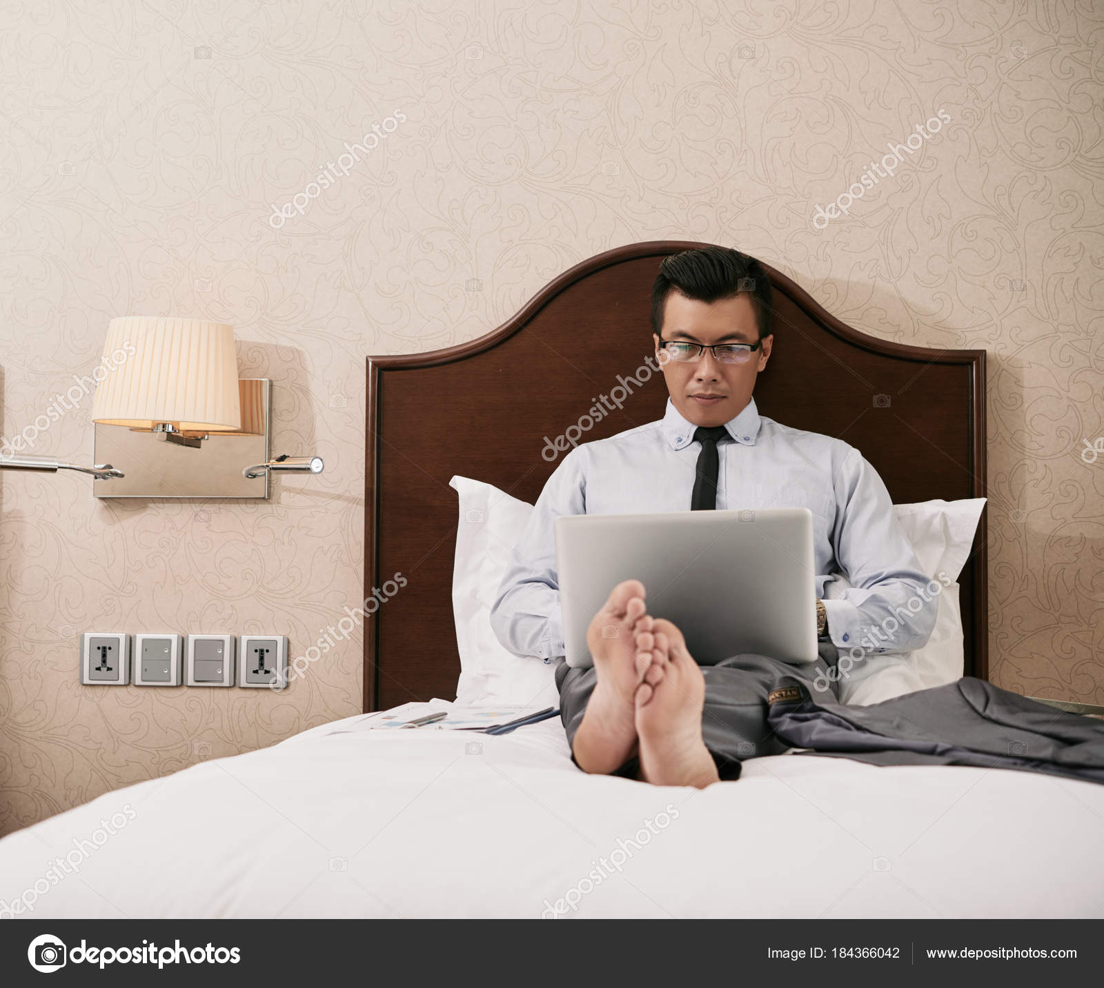 Barefoot Businessman Lying Bed Working Laptop Hotel Room — Stock Photo ...
