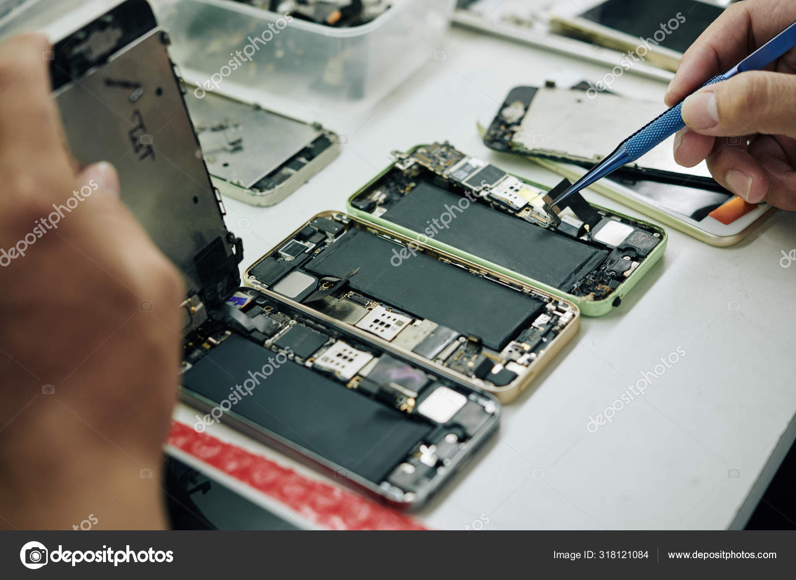 Repairman Using Fixed Smartphone Reference Repairing Two Other ...