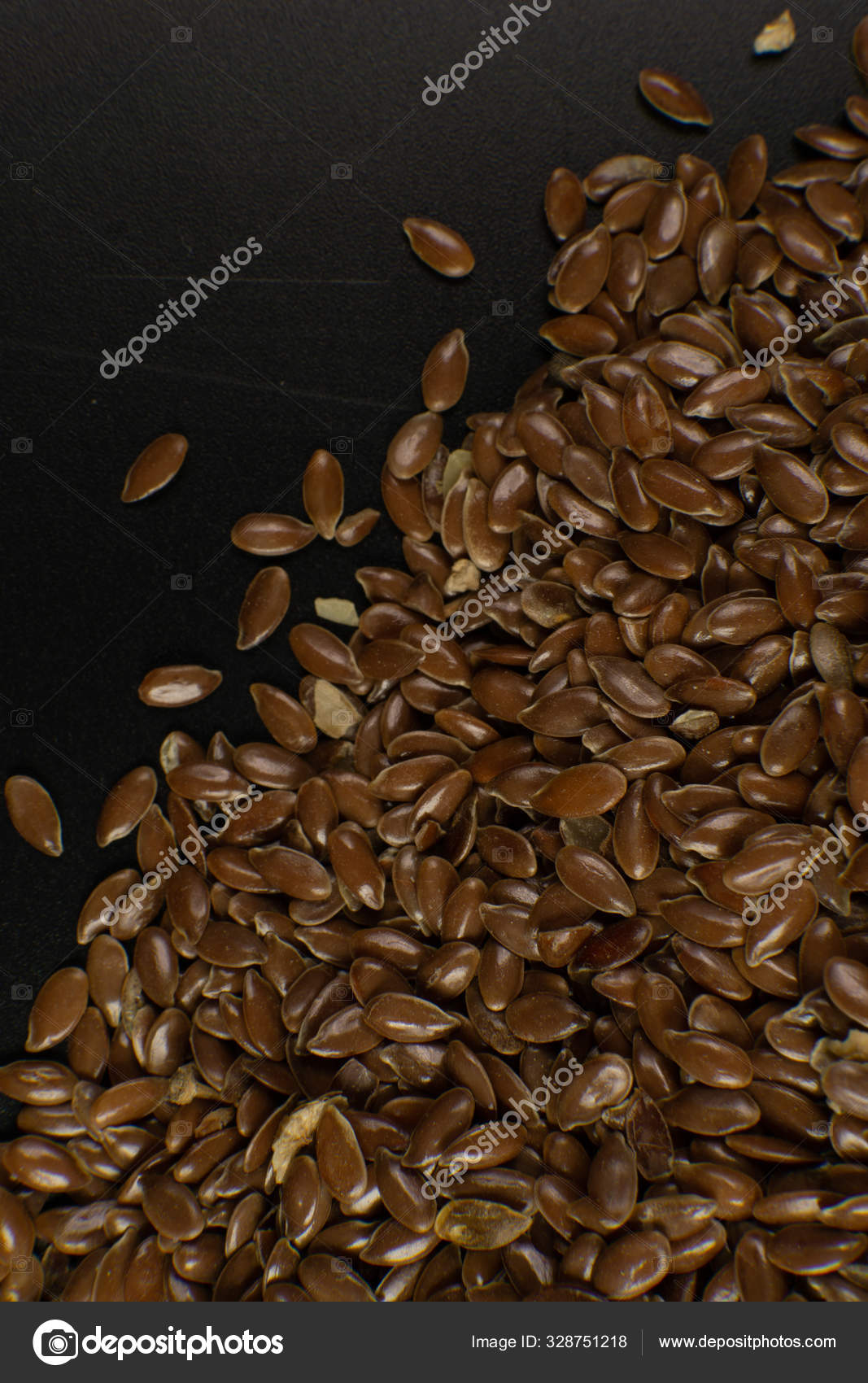 Brown Flax seed. Also known as Linseed, Flaxseed and Common Flax. Closeup of grains, background ...