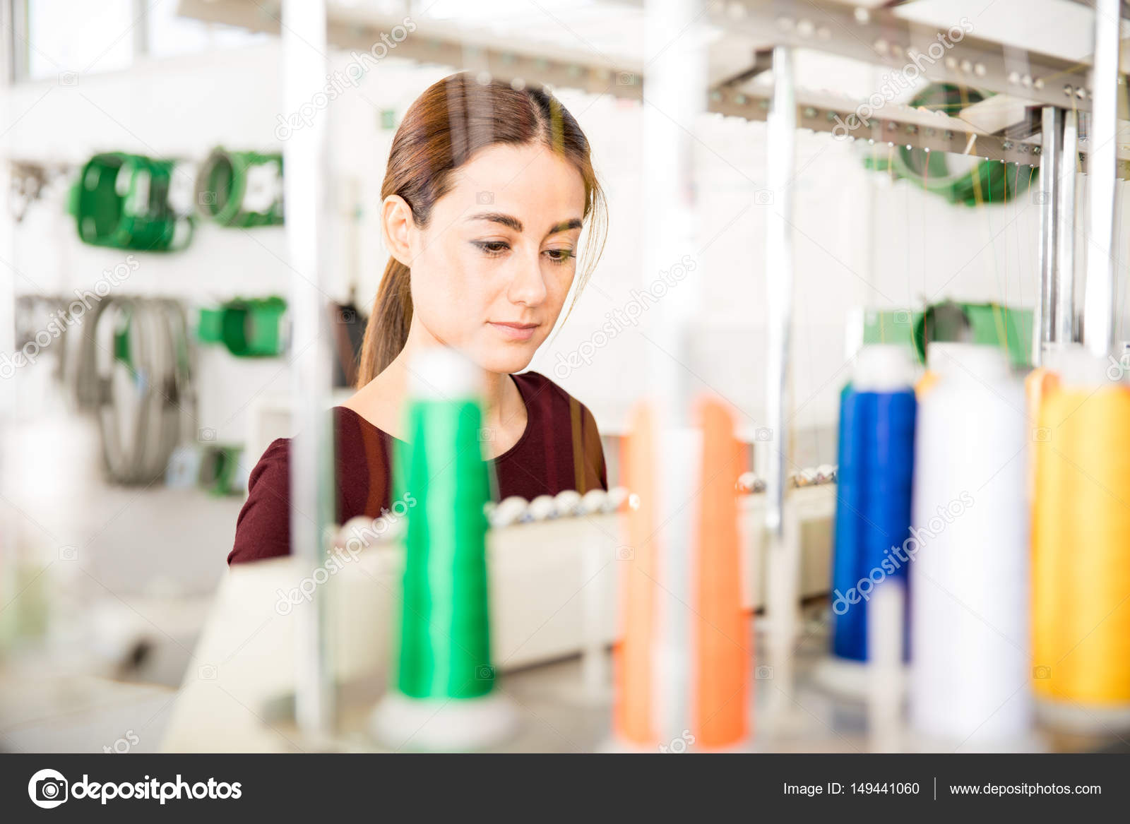 Woman using an embroidery machine Stock Photo by ©tonodiaz 149441060