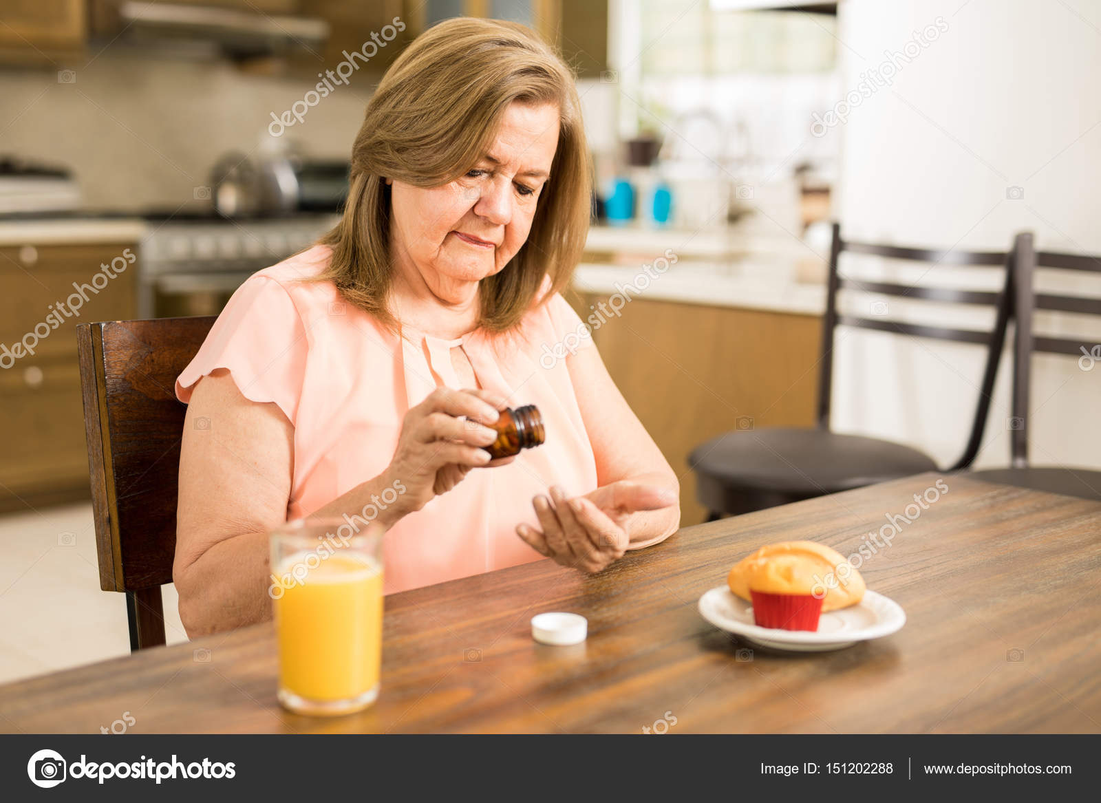 Granny taking medication with breakfast — Stock Photo © tonodiaz #151202288