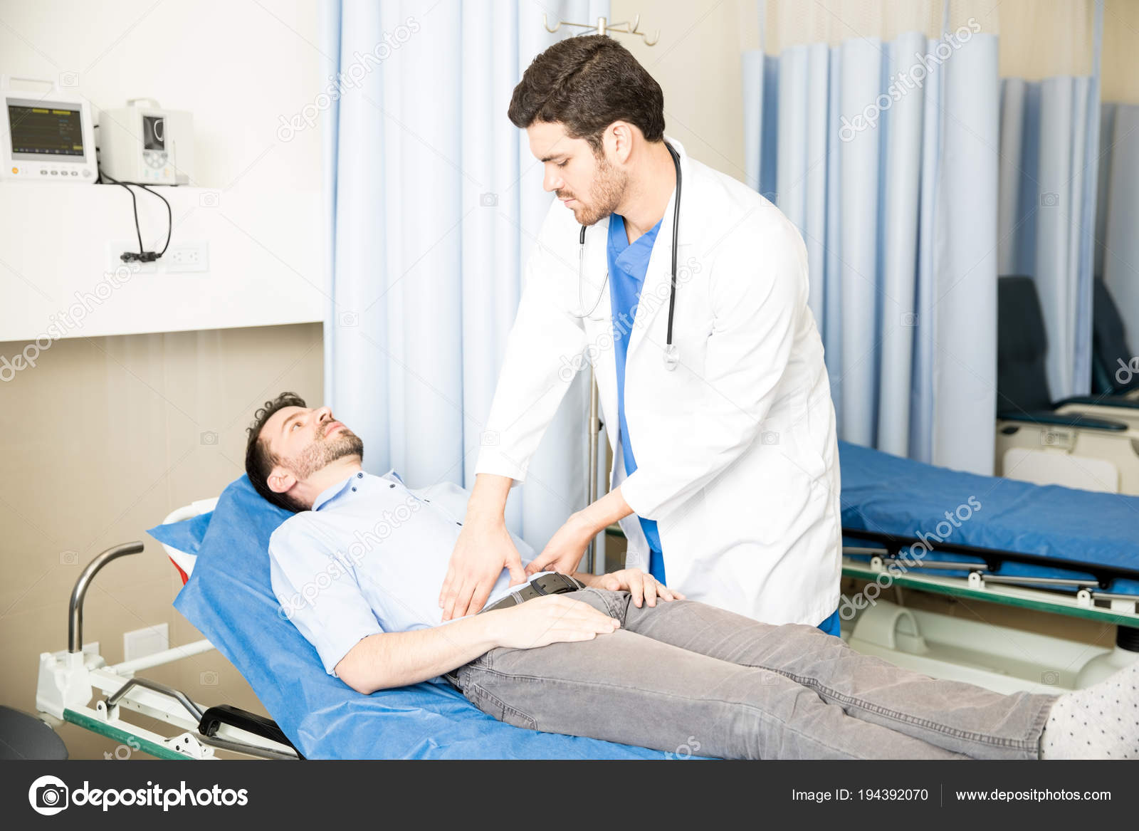 Handsome Young Doctor Checking Abdomen Male Patient Lying Bed Emergency ...