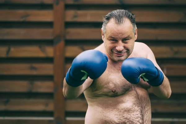 bad big fat boxer with blue gloves - Stock Image - Everypixel