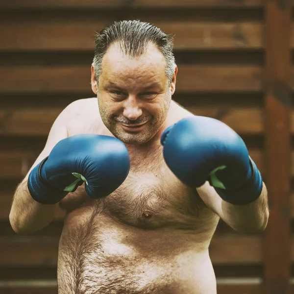 bad big fat boxer with blue gloves - Stock Image - Everypixel