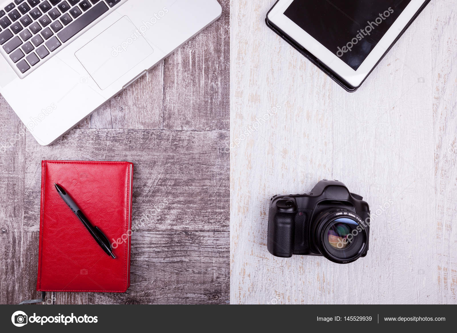Over top photo of camera, laptop, writing notebook and sunglasse ...