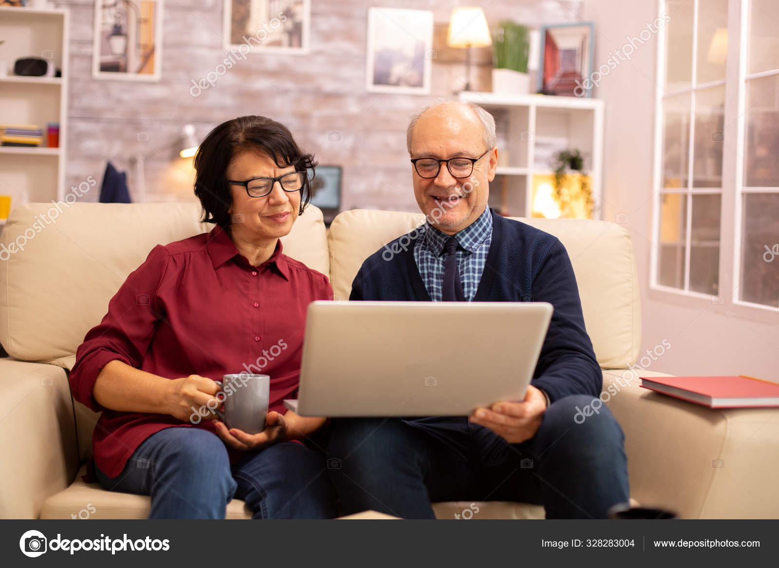 Elderly old couple using modern laptop to chat with their grandson ...