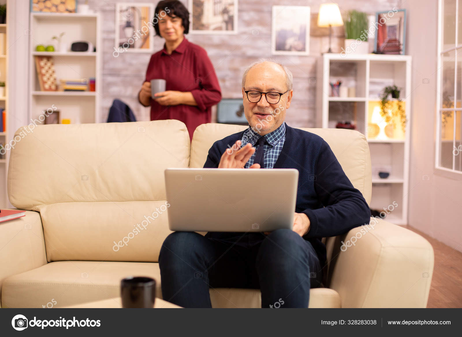 Elderly old couple using modern laptop to chat with their grandson ...
