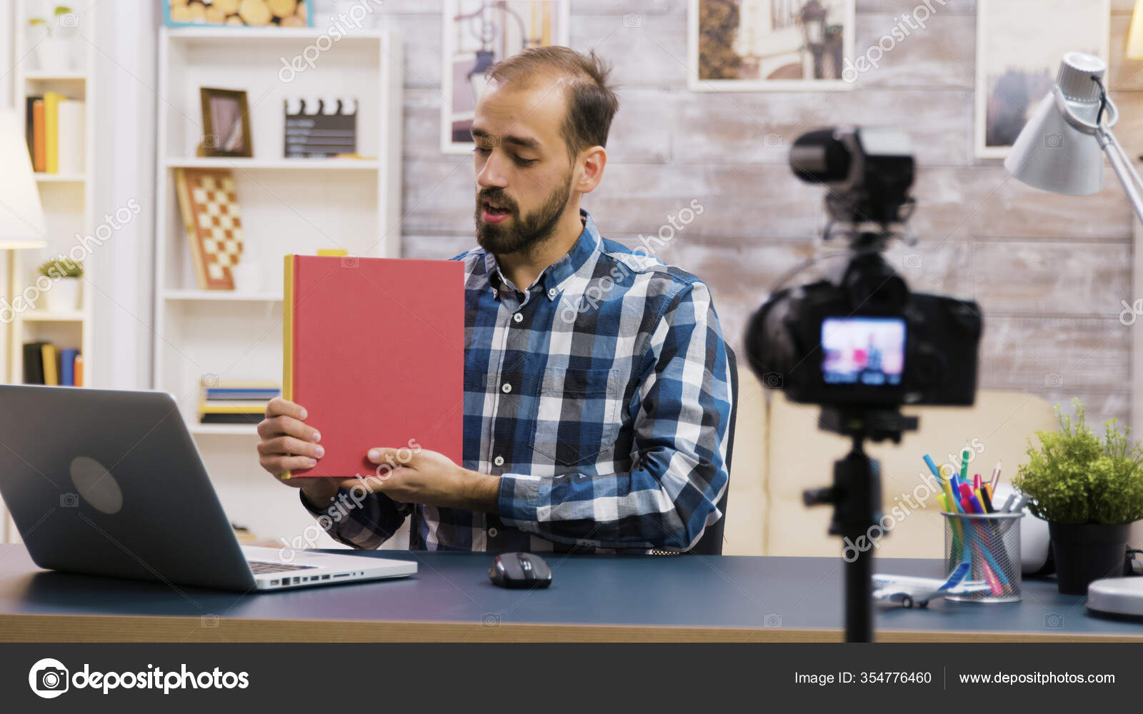 Famous young vlogger recording a review of a book — Stock Photo ...