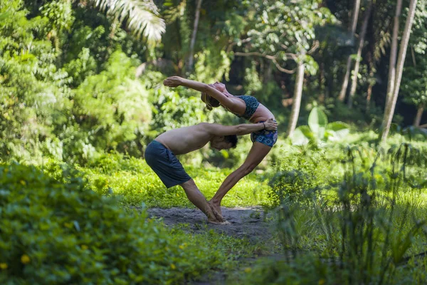 young couple doing outdoors acroyoga workout - beautiful and relaxed ...