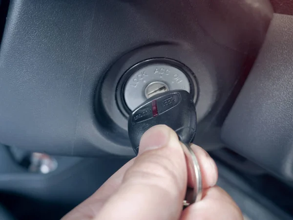Women driver hand inserting car key and starting engine. Stock Photo by ...